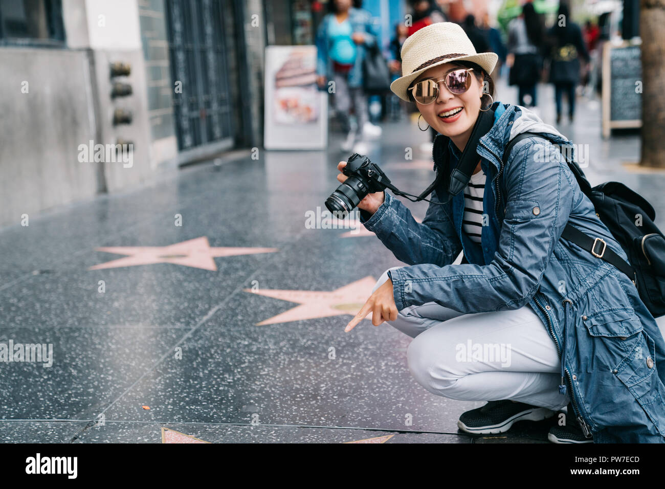 female photographer joyfully taking picture of the stars sign on the ...