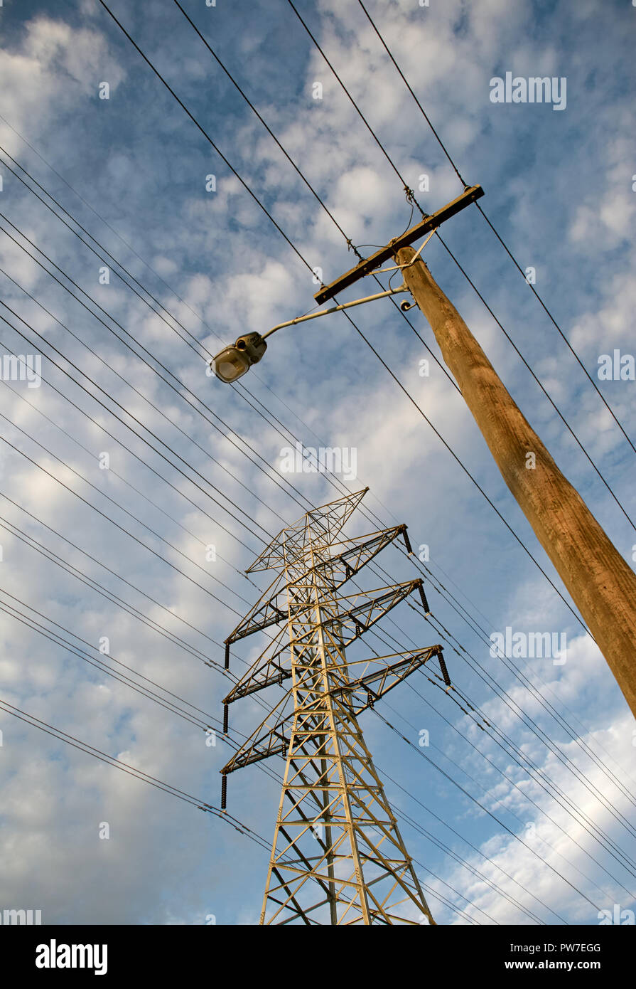 Street light and power pylon against a dramatic blue sky Stock Photo ...