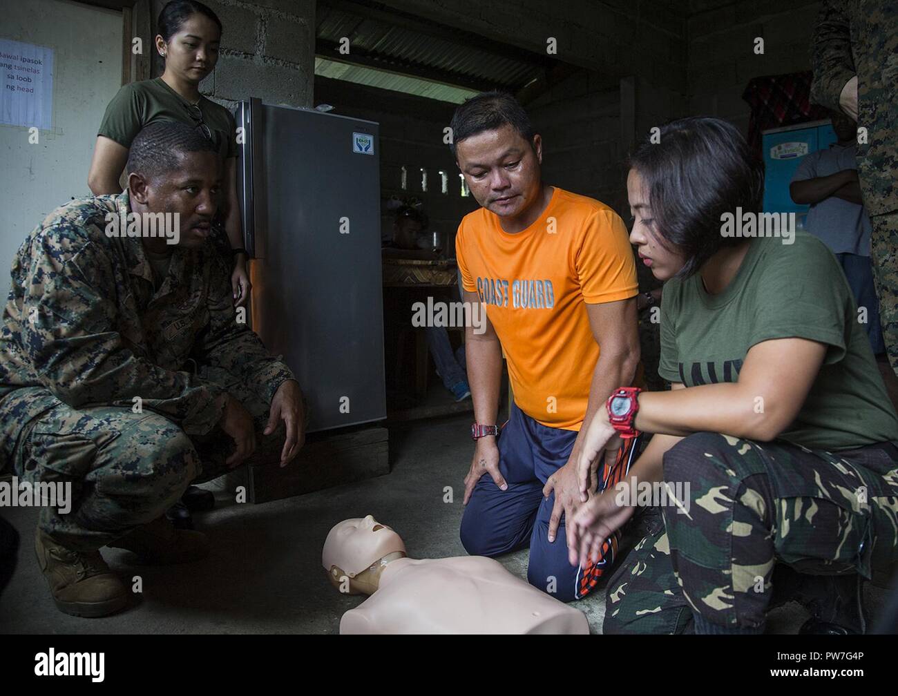 U.S. Navy HM1 Michael Downey, alongside members of the Philippine Navy ...