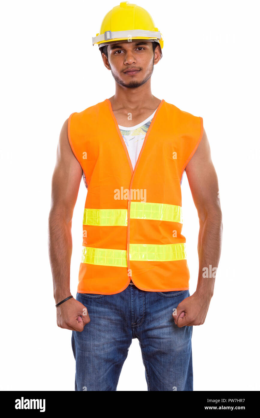 Studio shot of young handsome Indian man construction worker sta Stock ...