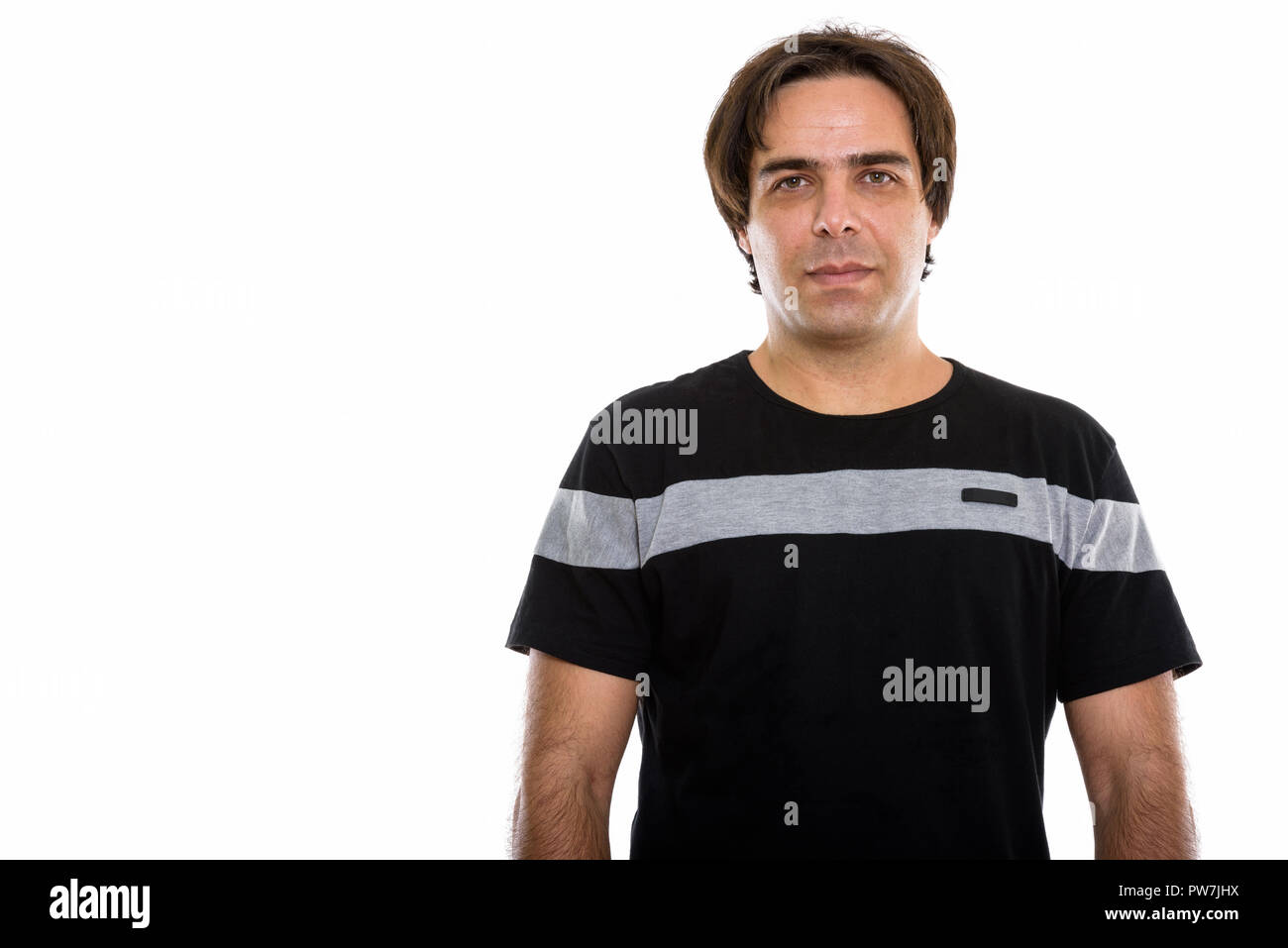 Studio shot of young Persian man standing Stock Photo - Alamy