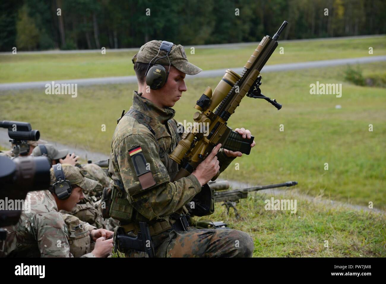 A German soldier loads a magazine into his weapon during the European ...
