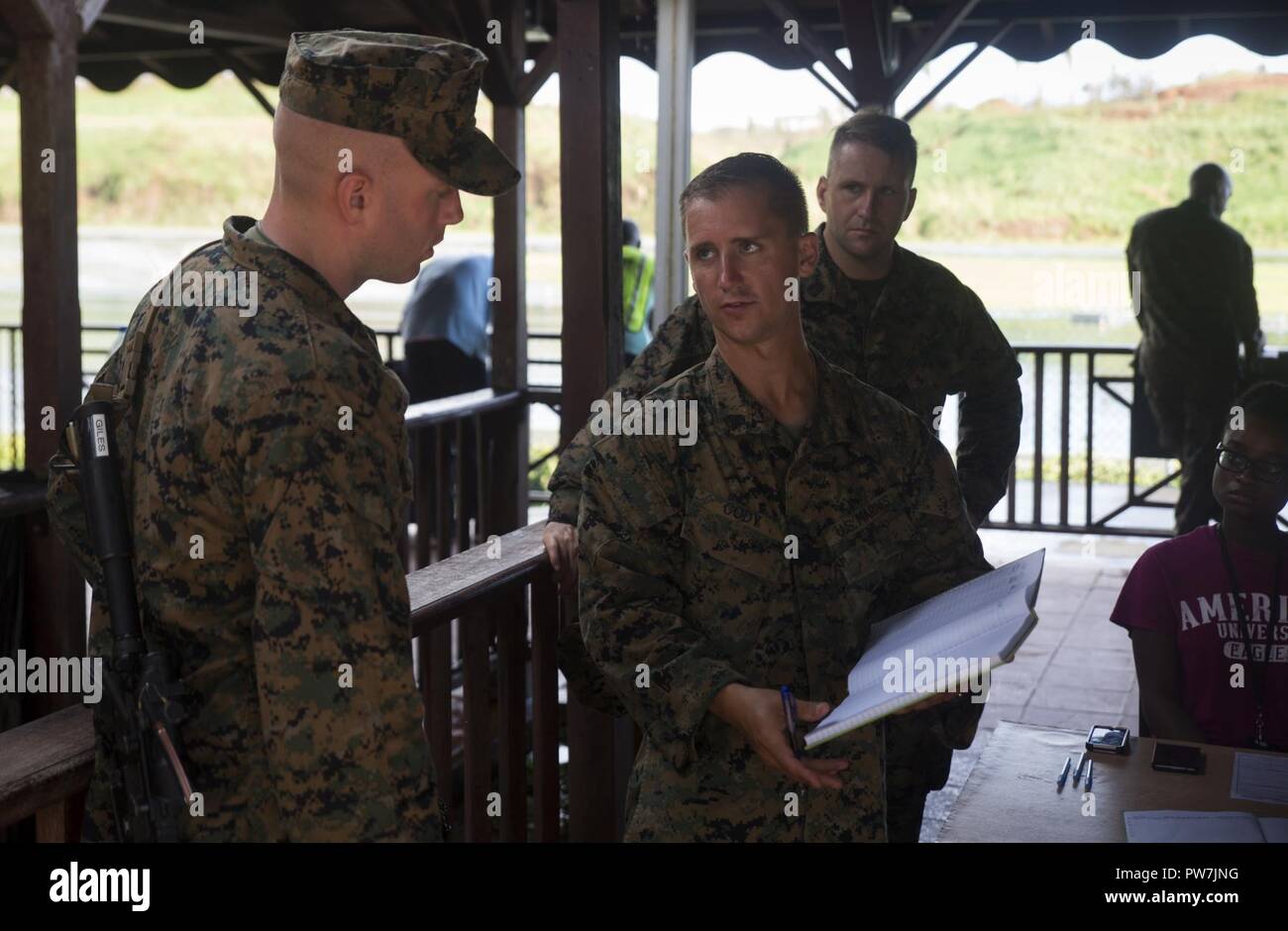 U.S. Marine Sgt. Austin Cody, center, the evacuation control center ...