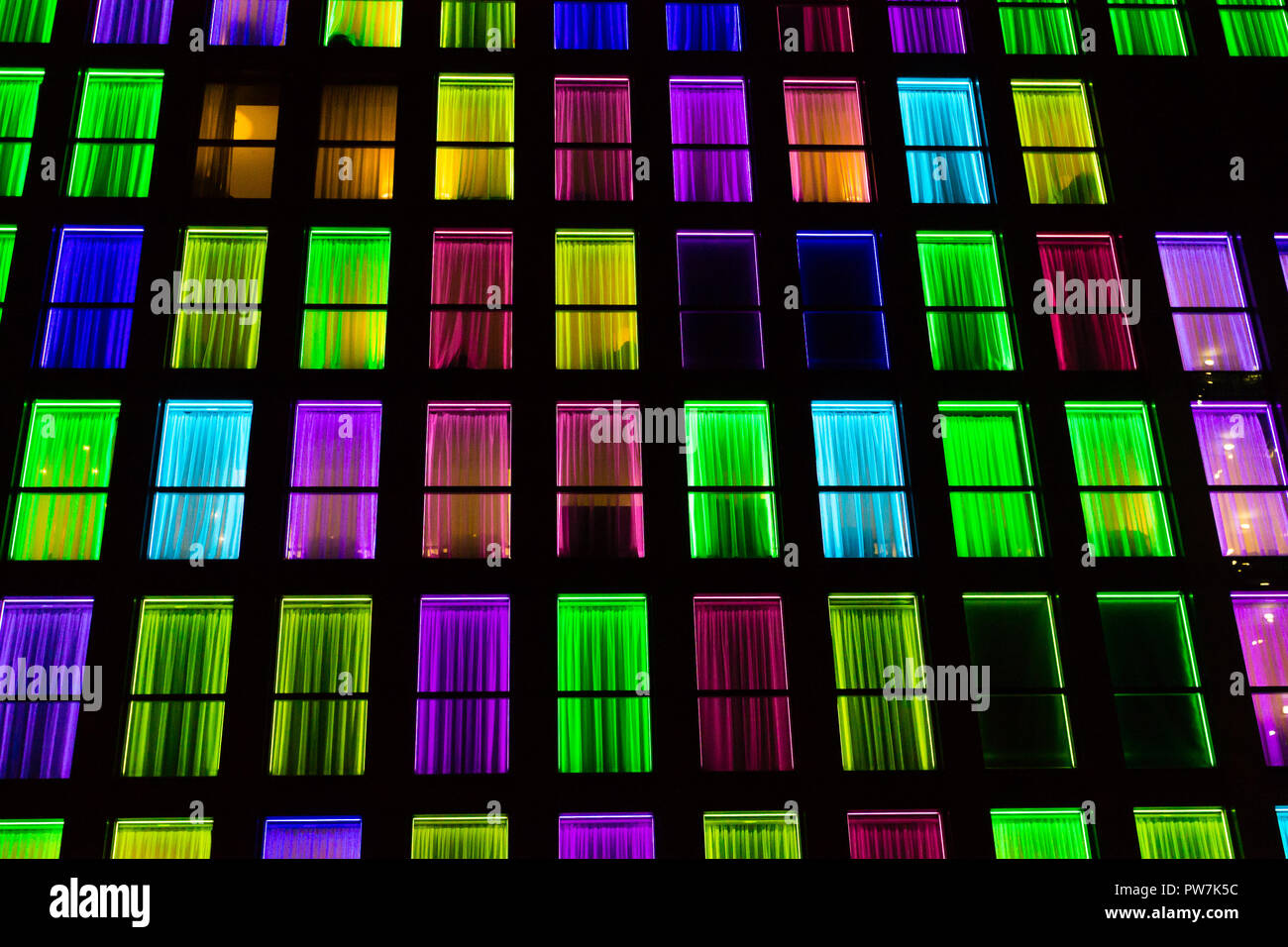 Colored windows texture. Windows illuminated by neon lights background ...