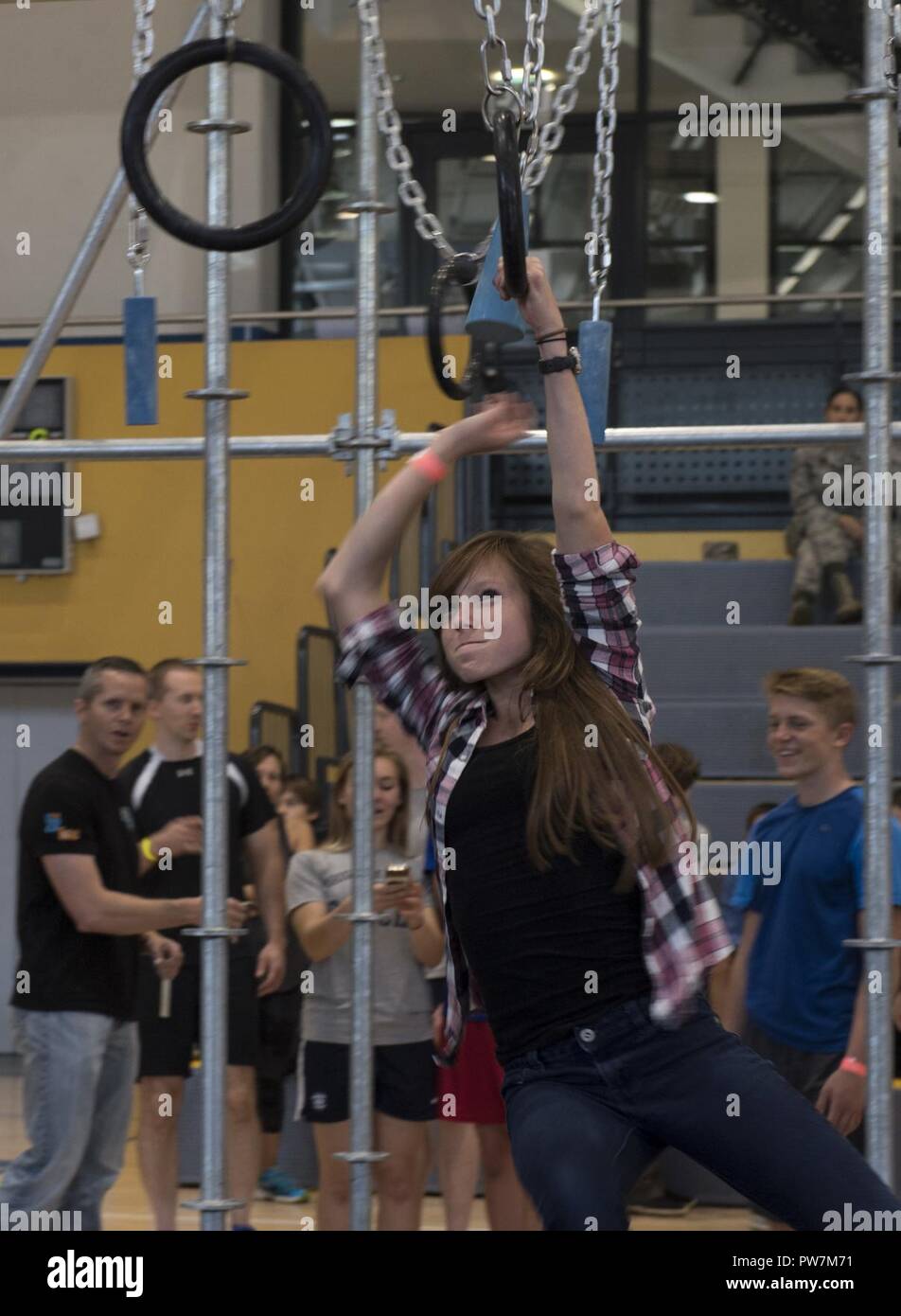 A young girl swings to reach another hand hold on the Alpha Warrior’s ...