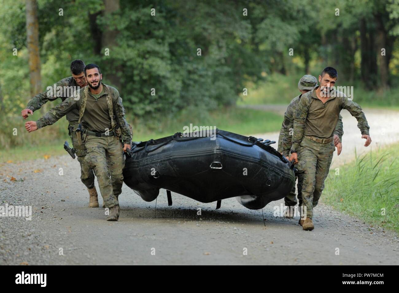 Spanish soldiers carry an inflatable landing craft after conducting the ...