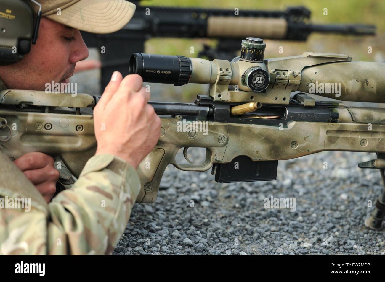 A British soldier chambers a new round in his sniper rifle during the ...