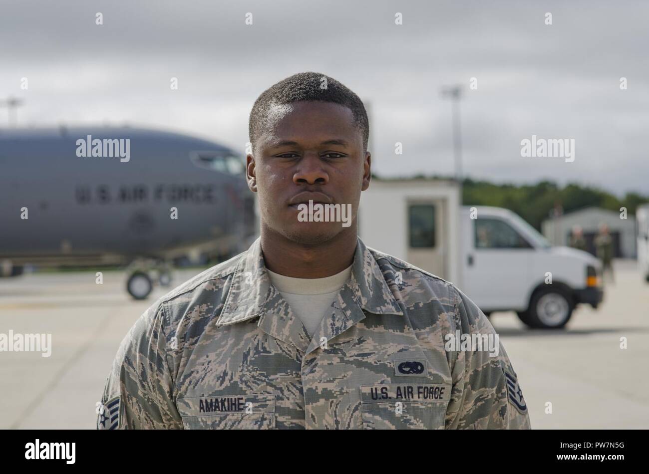 Staff Sergeant Andy Amakihe, crew chief, stops for a moment and looks ...