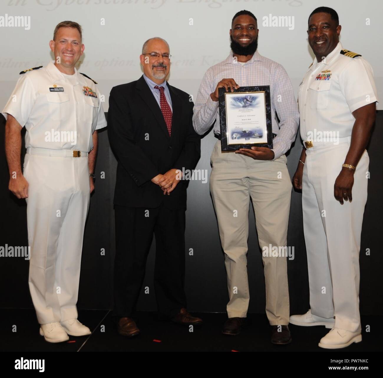 DAHLGREN, Va. - Brent Reid receives his certificate of achievement from ...