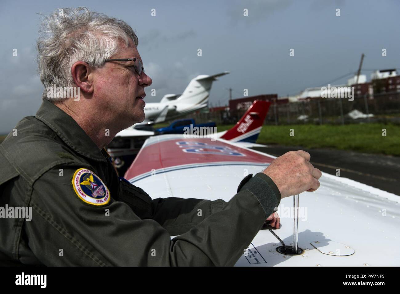 Captain William Henry a Civil Air Patrol pilot does his post-flight ...