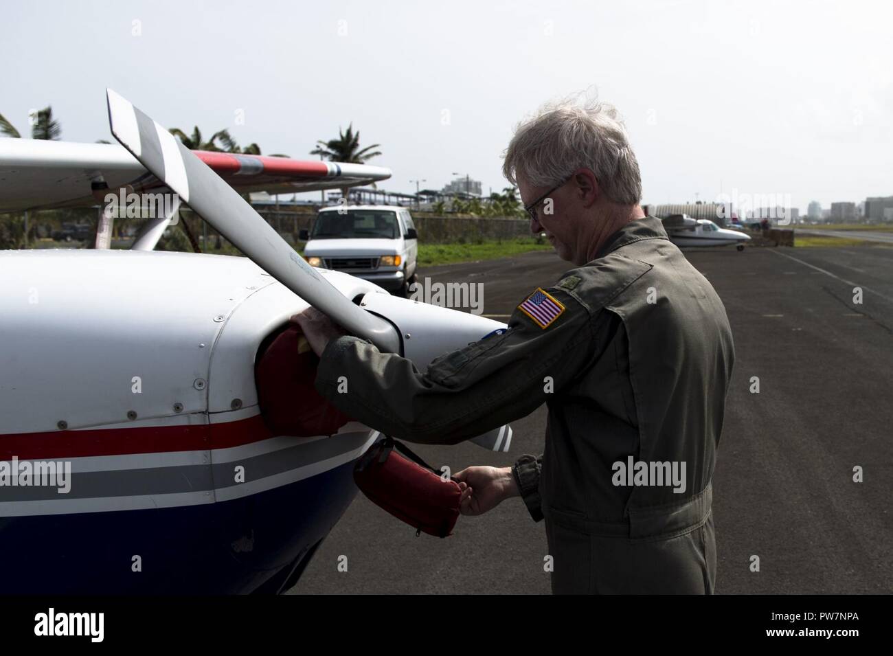 Captain William Henry a Civil Air Patrol pilot does his post-flight ...