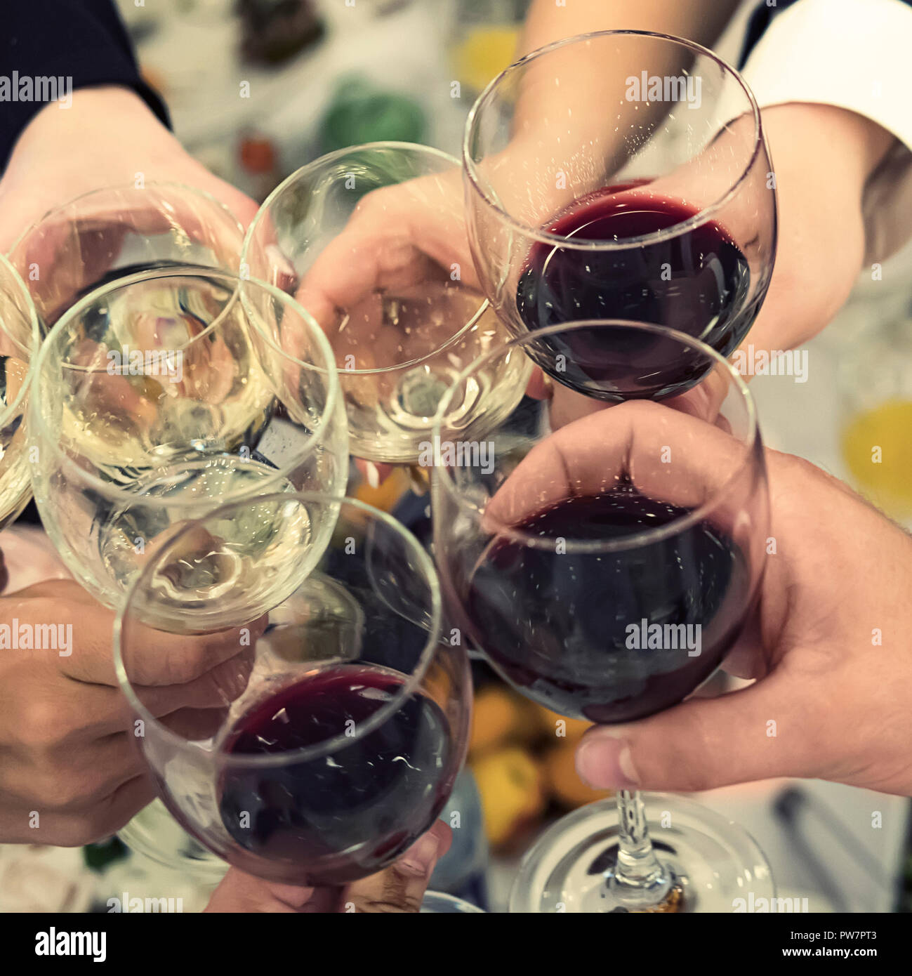 People clinking glasses above reataurant dinner table at some festive ...