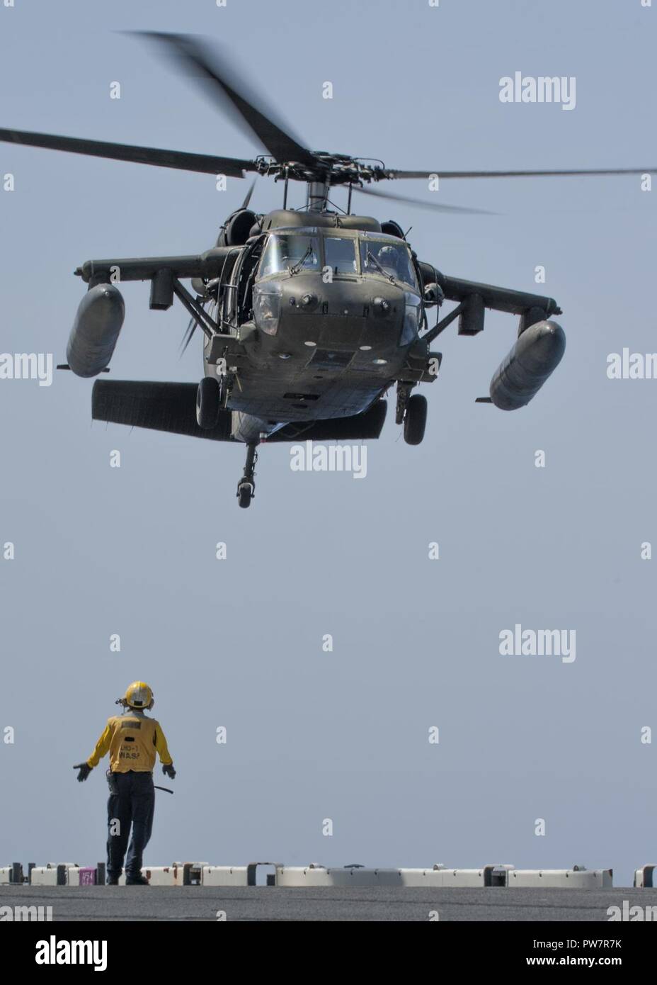 CARIBBEAN SEA (September 27, 2017) A Sailor directs an U.S. Army UH-60 ...