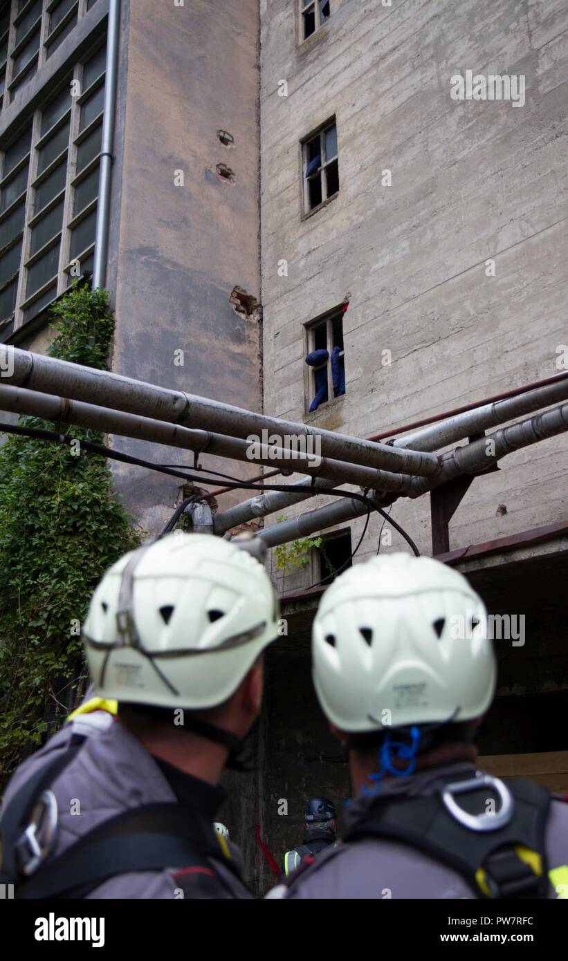 A Romanian search and rescue team assess a collapsed building where ...