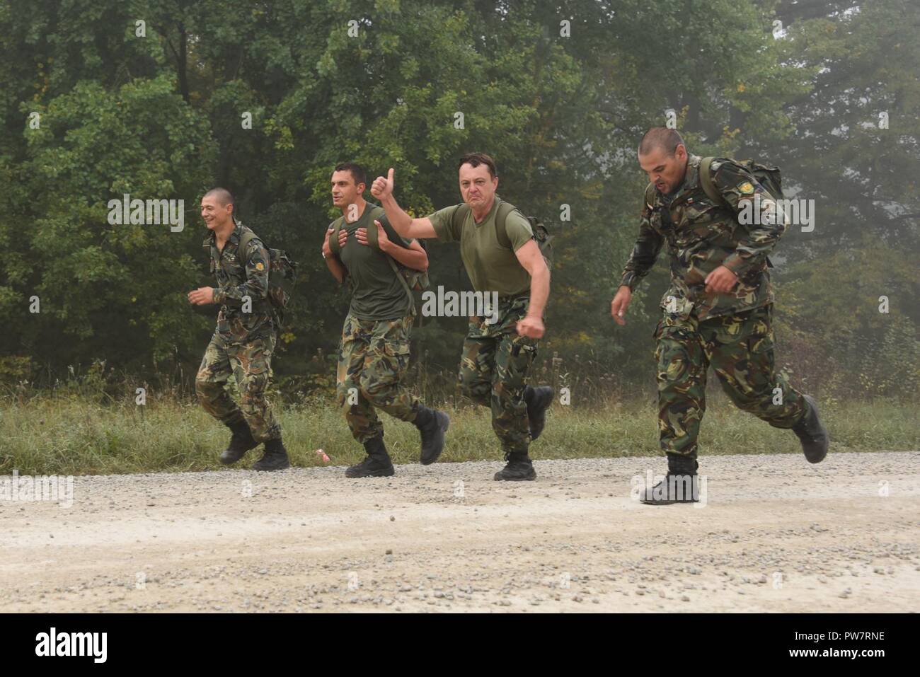 Bulgarian soldiers run the 12-mile ruck march as part of the European ...