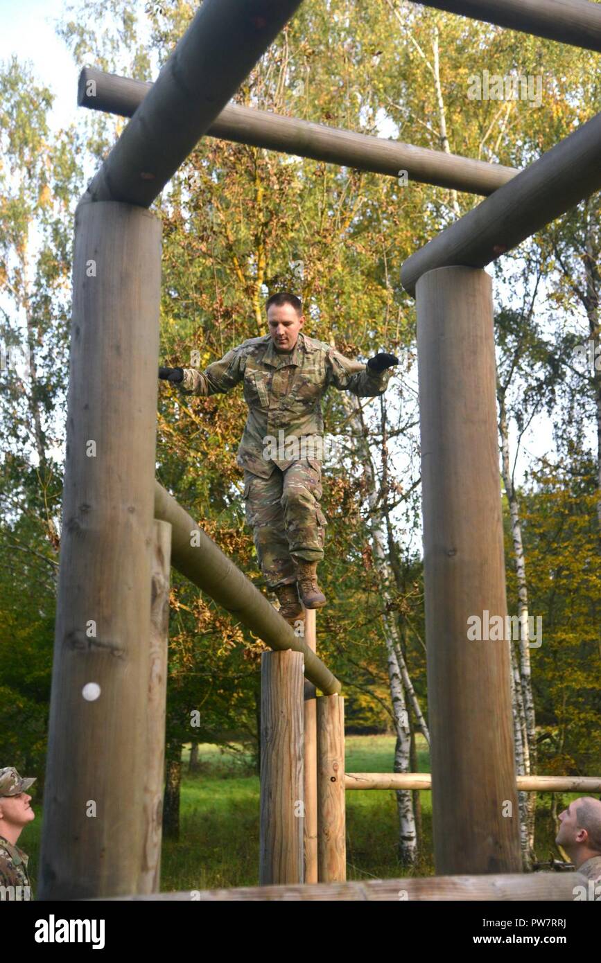 U.S. Soldiers assigned to 52nd Signal Battalion negotiates obstacles ...