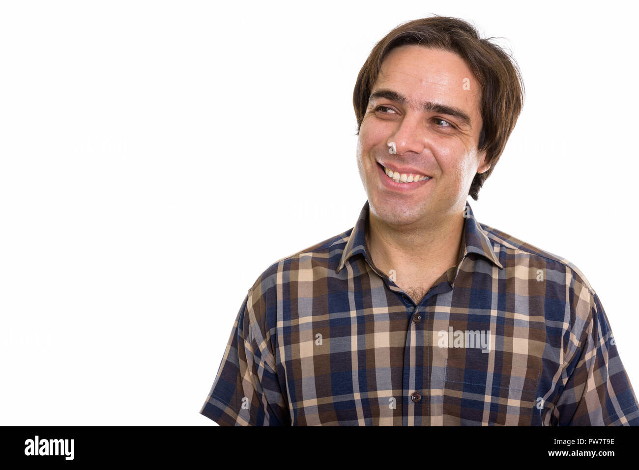 Studio shot of young happy Persian man smiling while thinking Stock ...