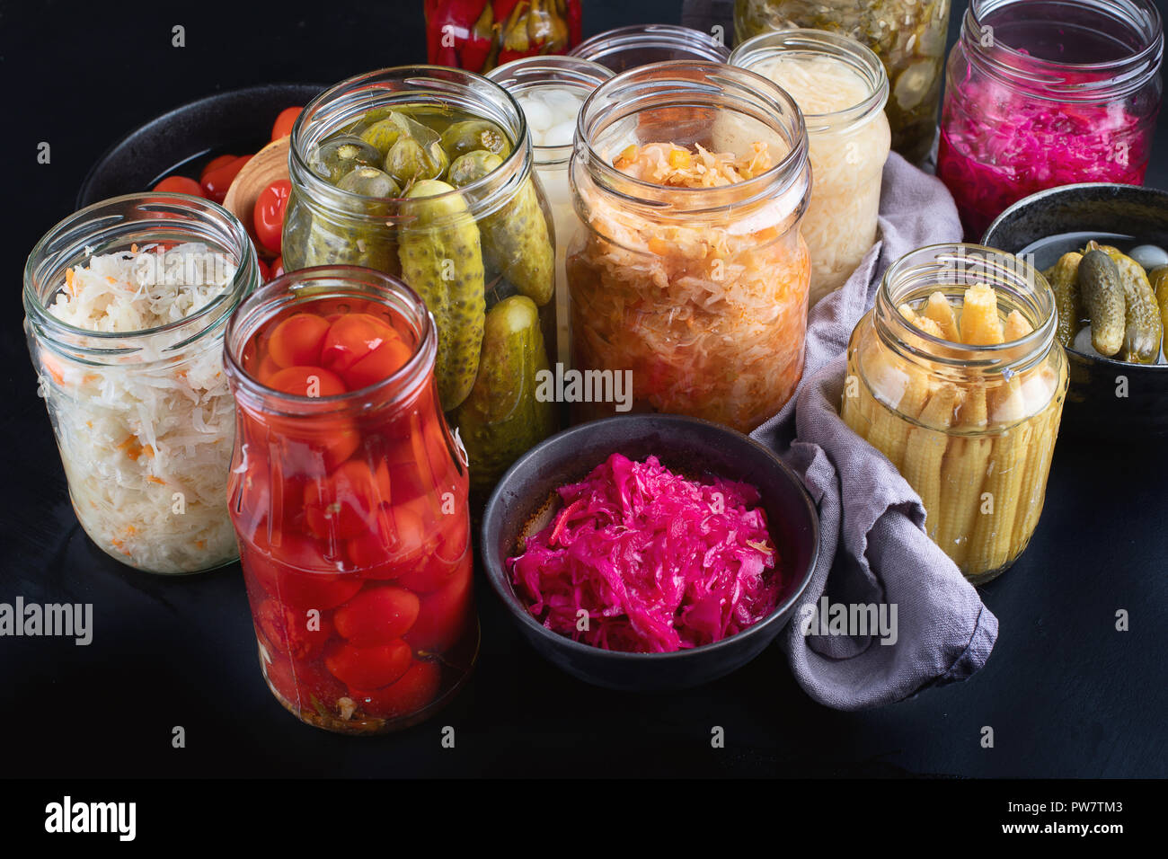 Fermented preserved food. Marinated pickles vegetables in glass jars ...
