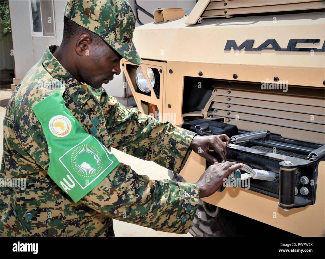 A member of the Uganda People’s Defence Force (UPDF) reviews one of the ...