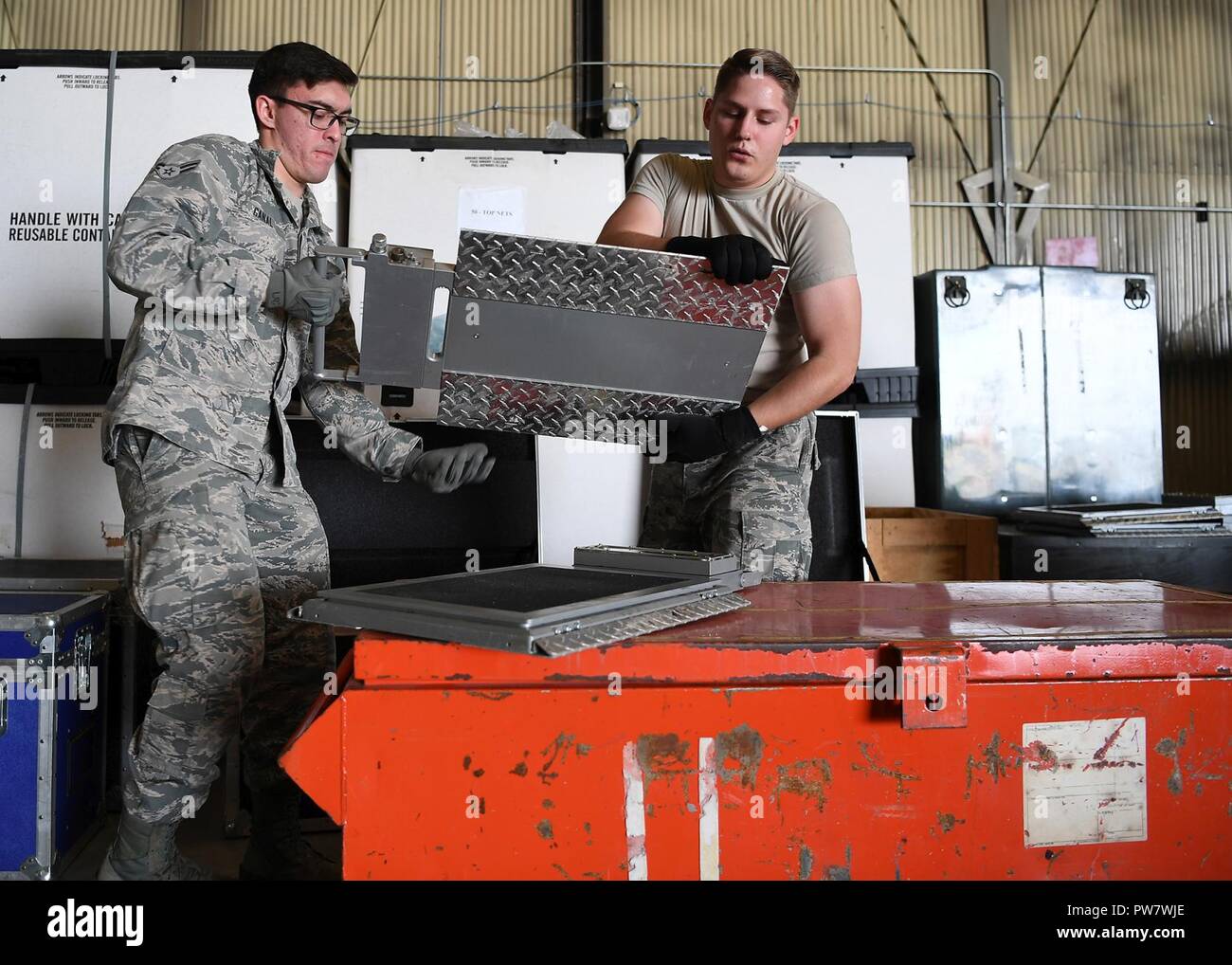 Airmen with the 319th Logistics Readiness Squadron lift a scale Sept ...