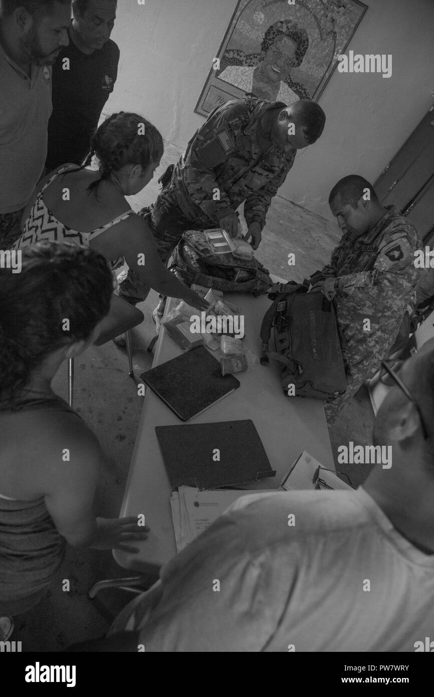 U.S. Army Cpt. Benjamin Stork (center), Flight Surgeon, and Sgt. Luis ...