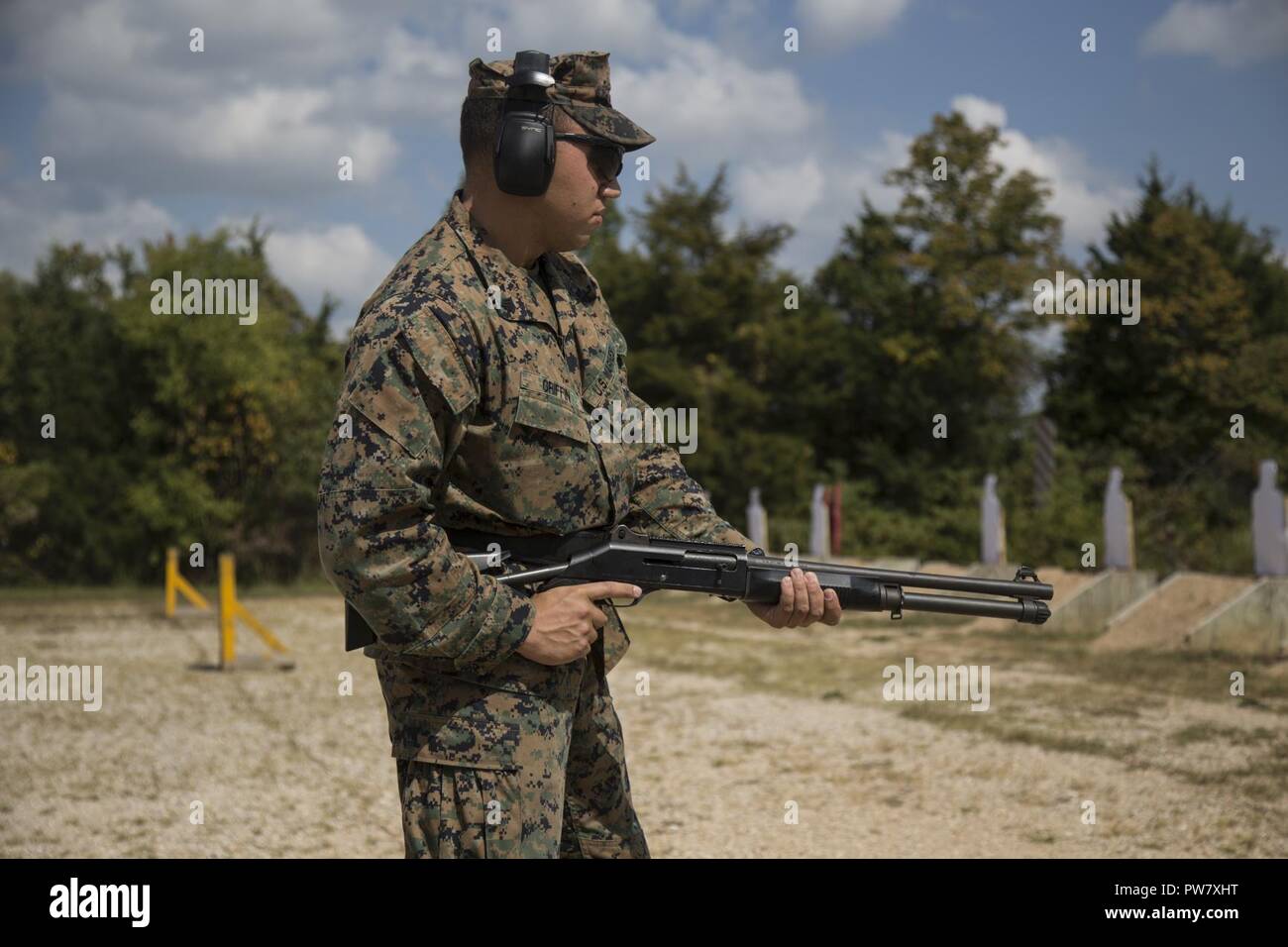 A U.S. Marine assigned to the Military Police Basic Course, fires the ...
