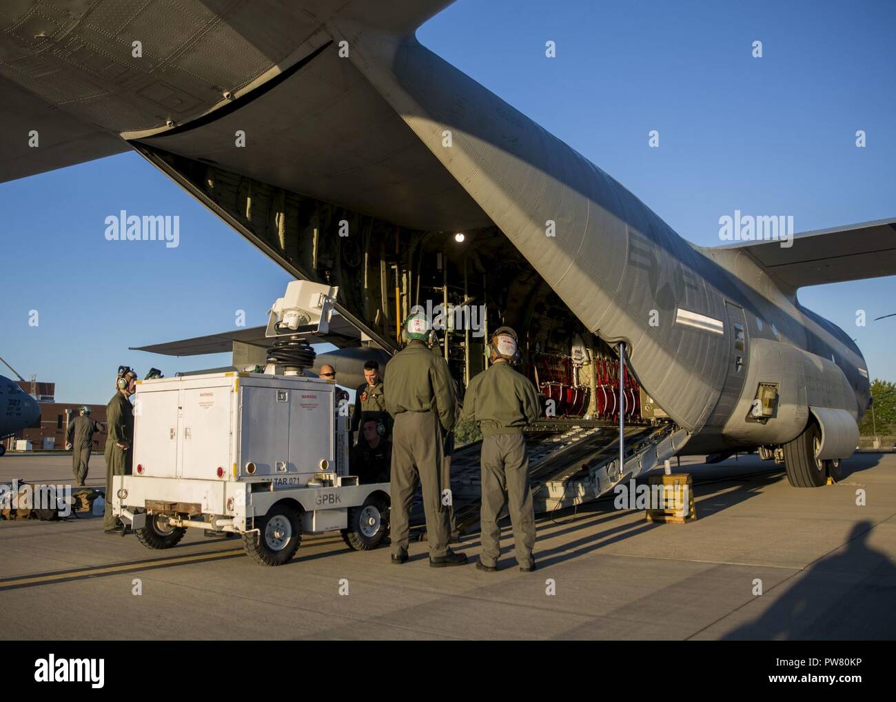U.S. Marines with Marine Helicopter Squadron One (HMX-1) load a KC-130J ...