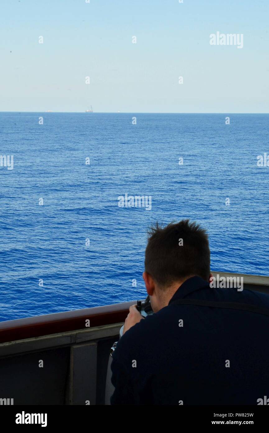 MEDITERRANEAN SEA (Oct. 1, 2017) Ensign Aaron Trowell uses an alidade ...