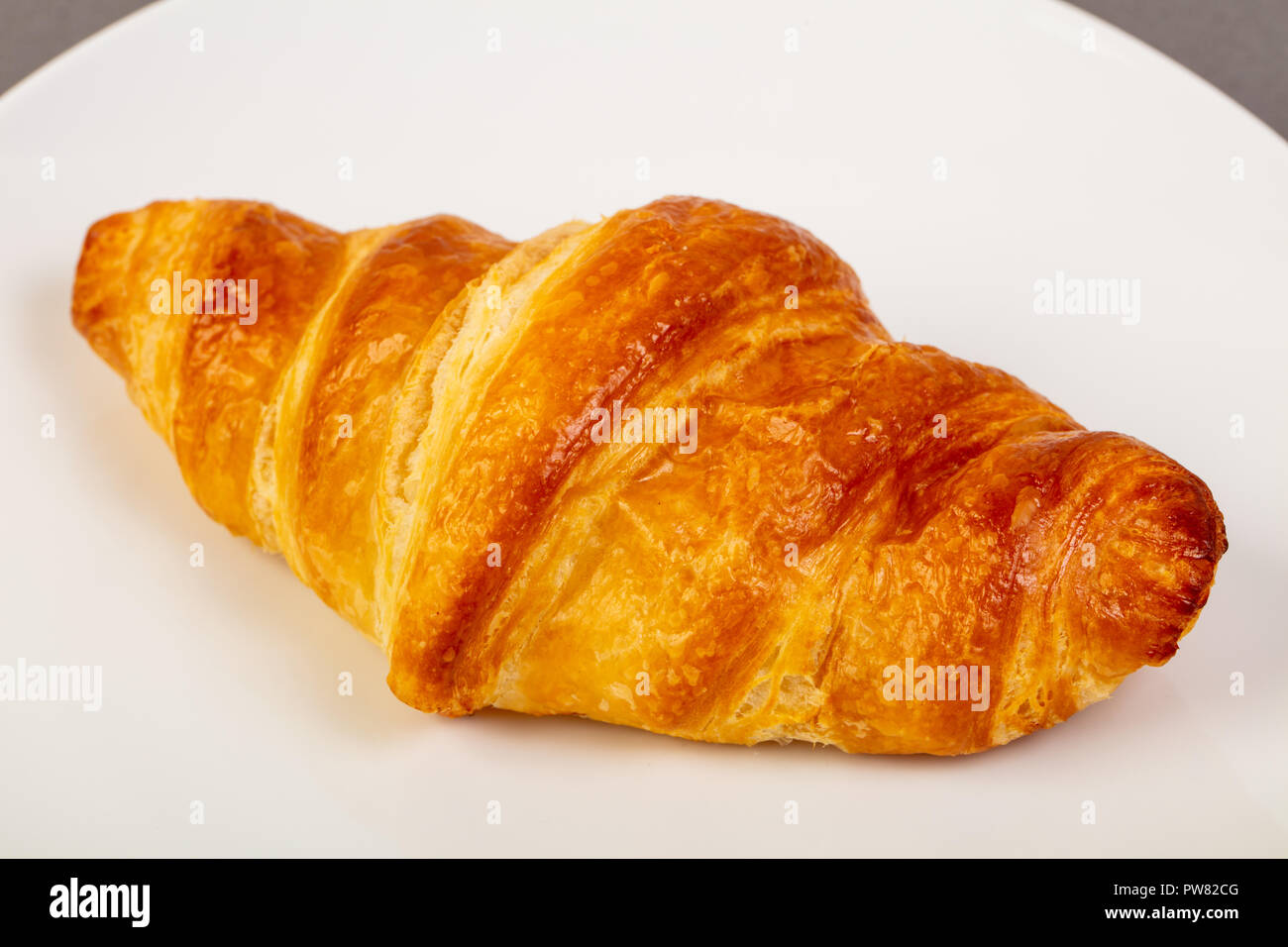 Fresh crust croissant in the plate Stock Photo - Alamy