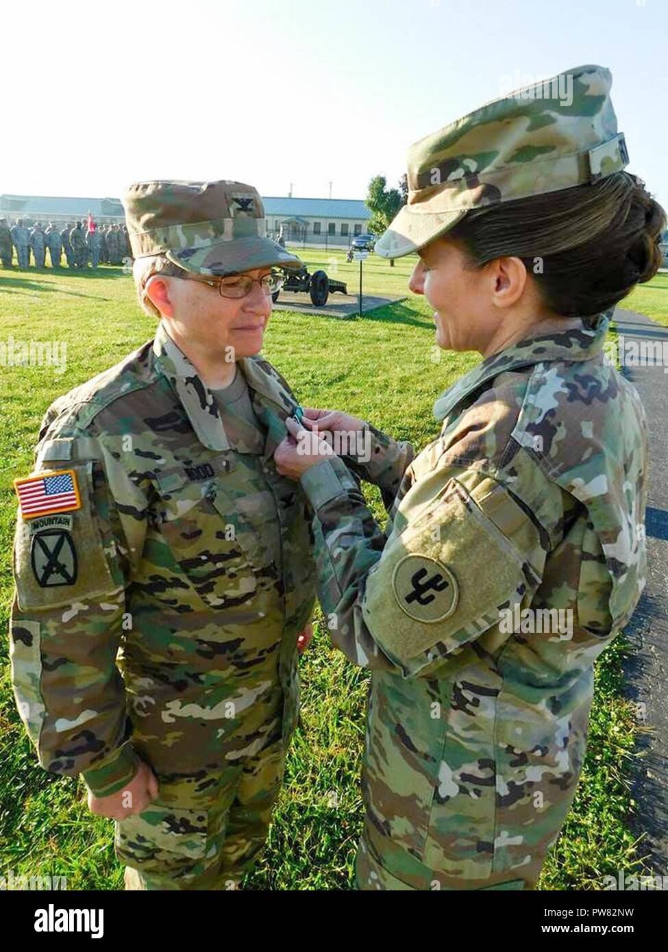 Col. Michelle Wood (left) receives an award for her leadership of the ...