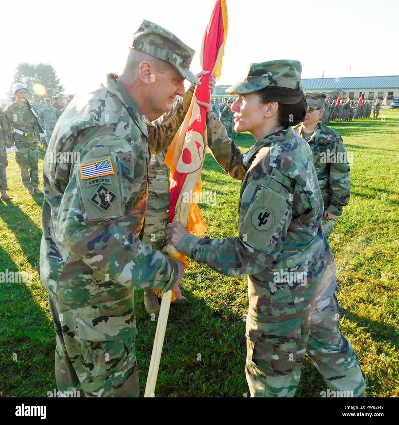 Col. Shad Smith (left) takes the unit colors from Col. Jennifer Ryan ...