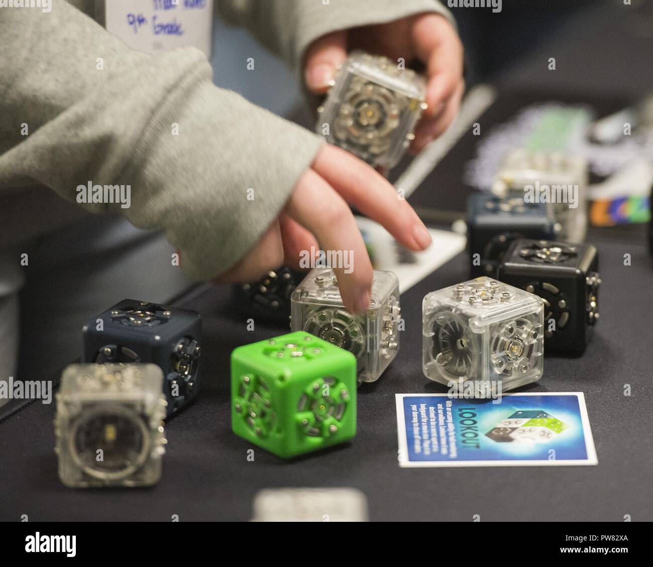 A student experiments with various combinations of robot cubes during ...