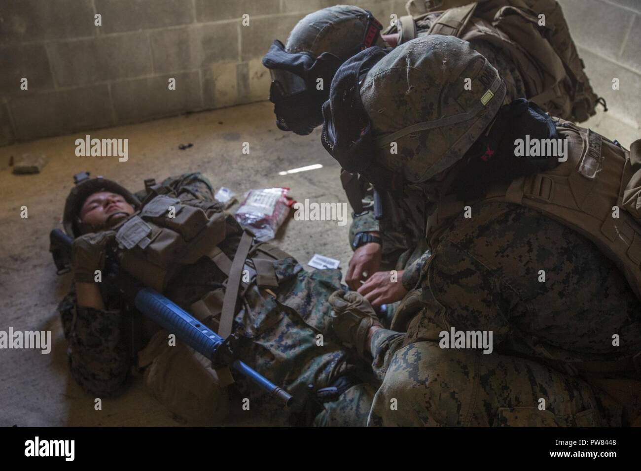 Marines with 2nd Battalion, 8th Marine Regiment apply tourniquets to a casualty during a ...