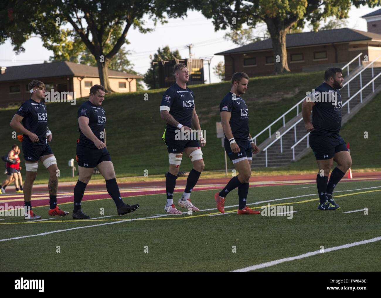 Royal Sailors assigned to the Royal Navy Rugby team walk together ...