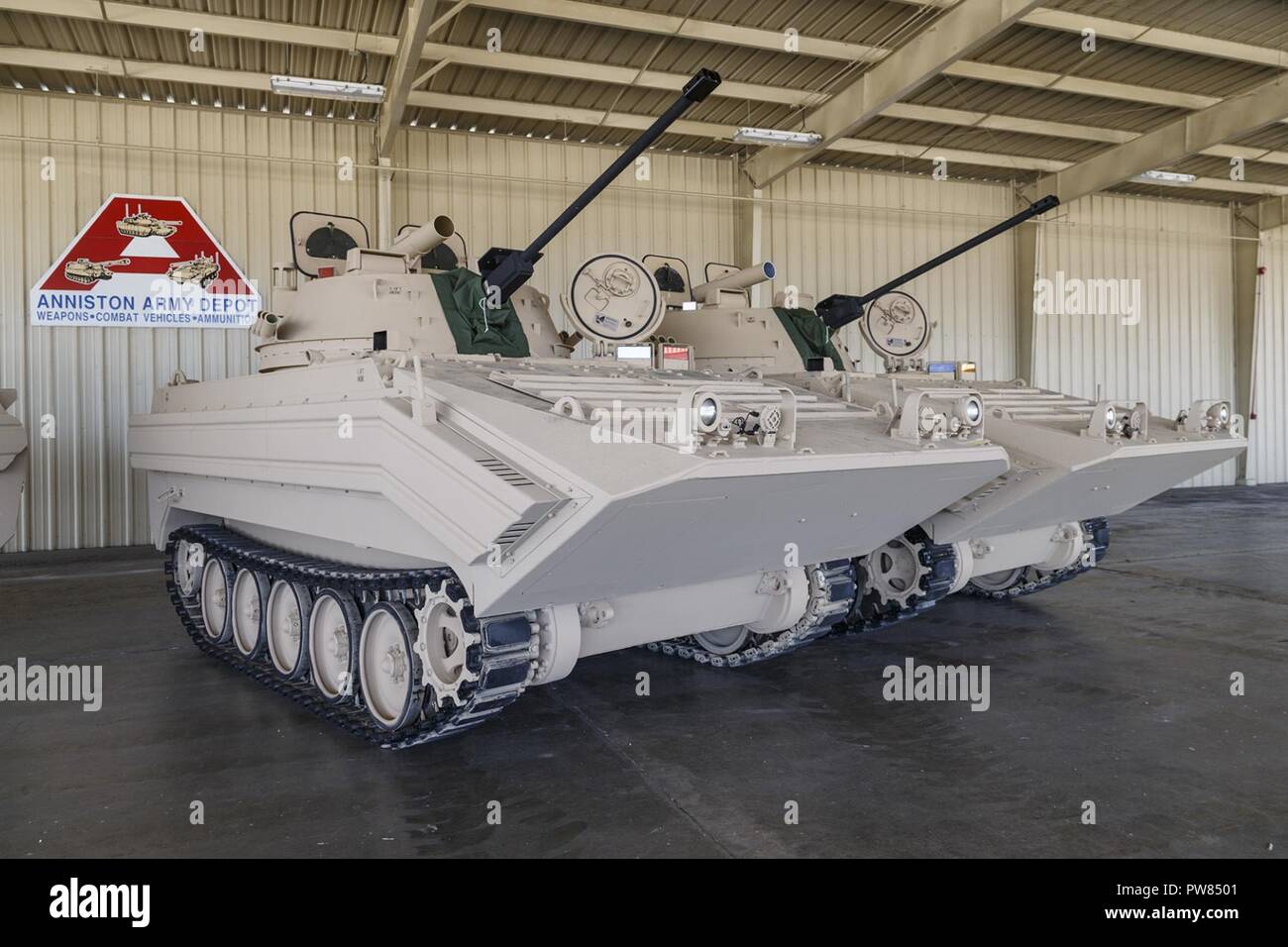 A line of M113A3/BMP-2 Opposing Forces Surrogate Vehicles stand ready ...