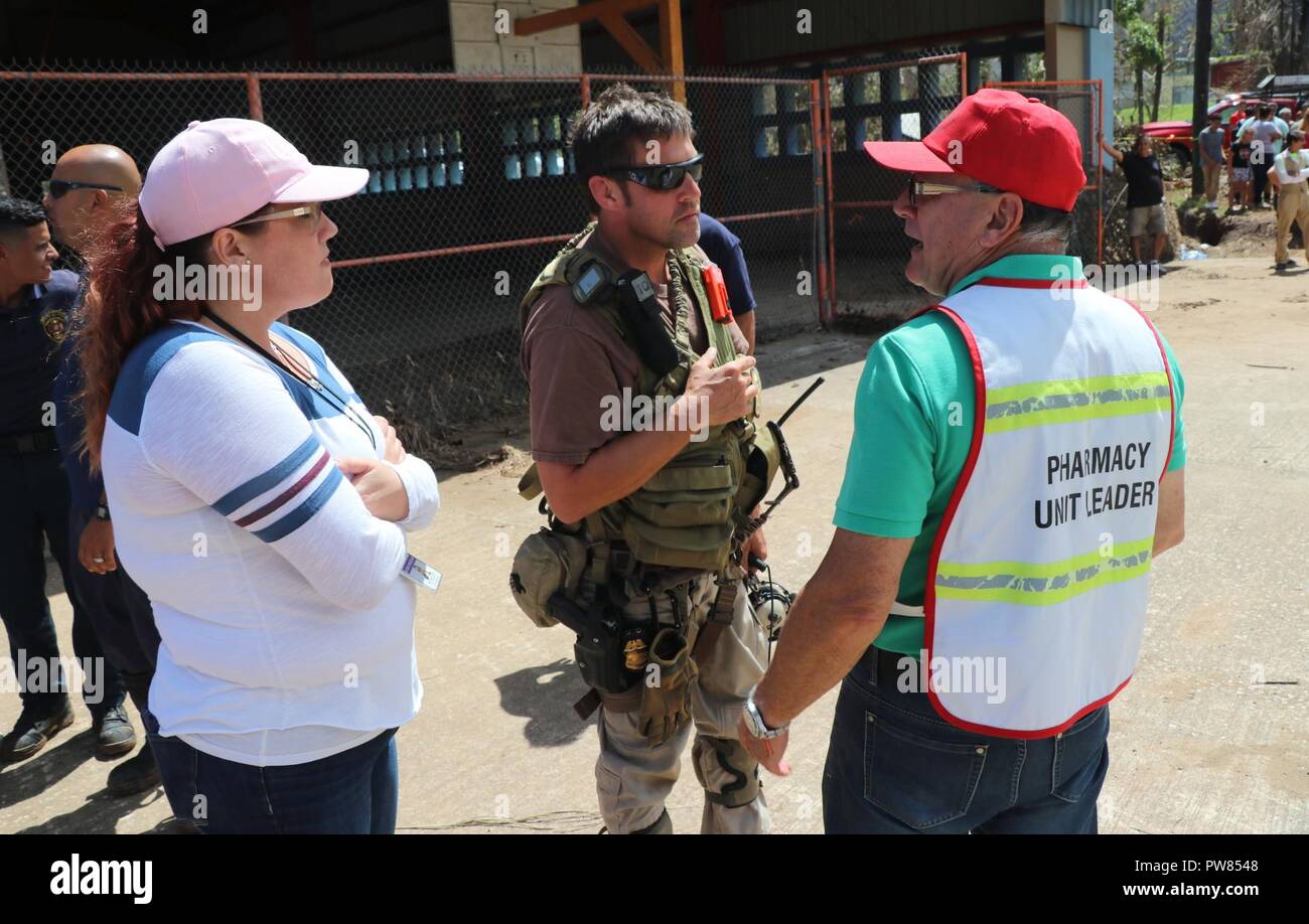 Aviation Enforcement Agent Mickey Mohol talks with Amilcar Rodriguez ...