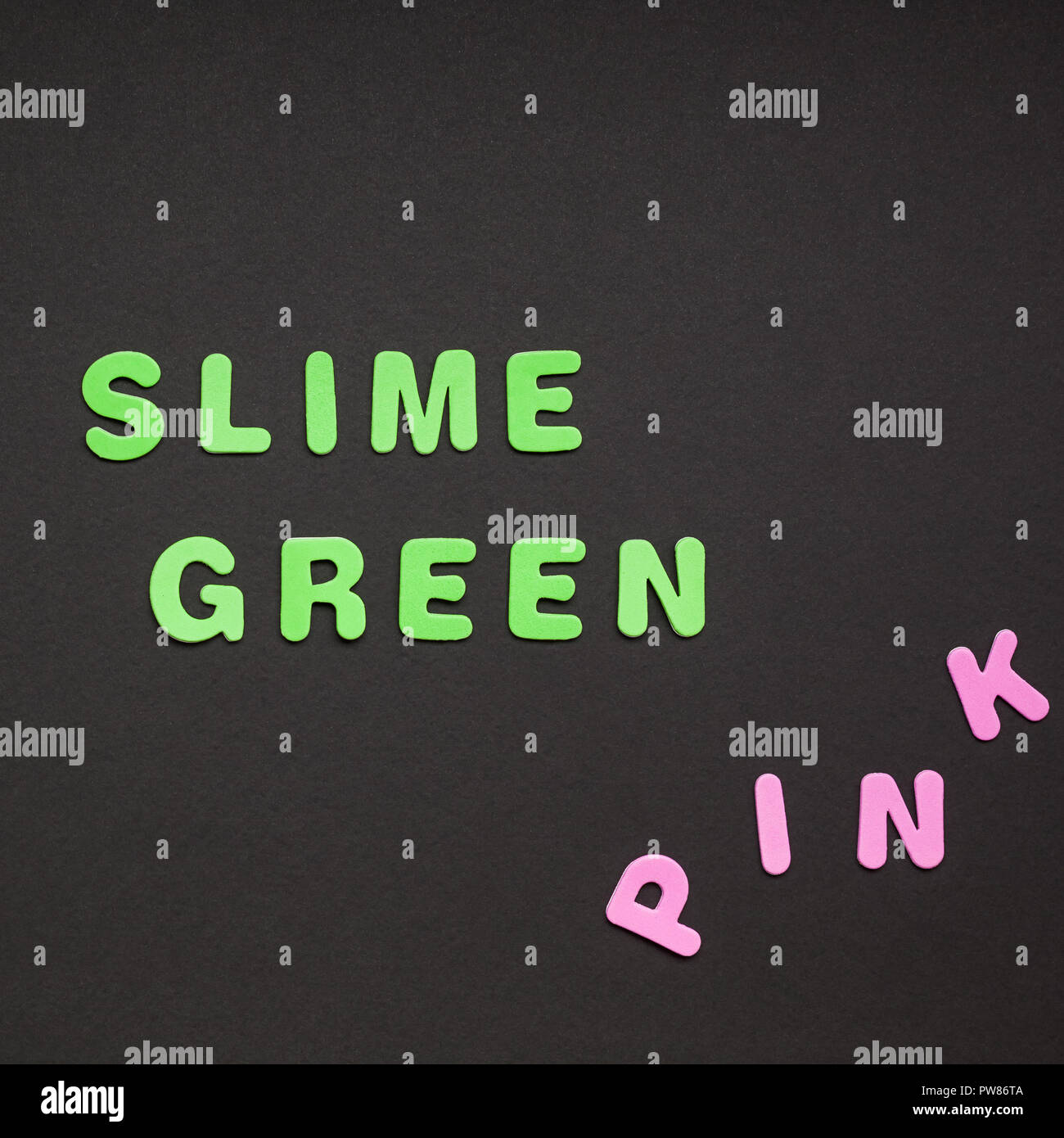 Creative colorful text made from plastic letters Slime green writing on ...