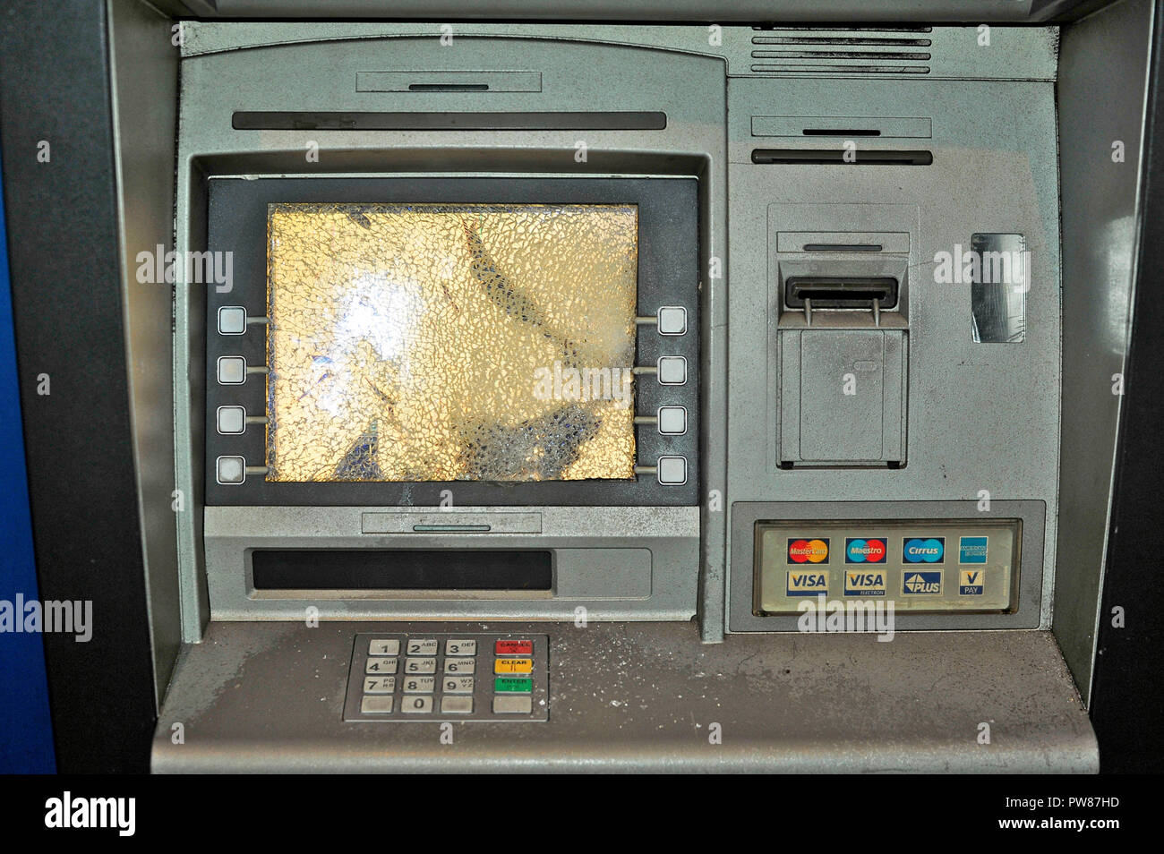 Vandalised ATM cash machine at night showing shattered screen Stock ...