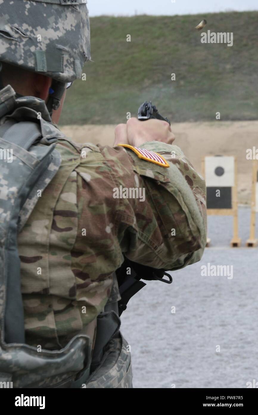 A Soldier fires the M9 pistol at a target during the range event of the ...