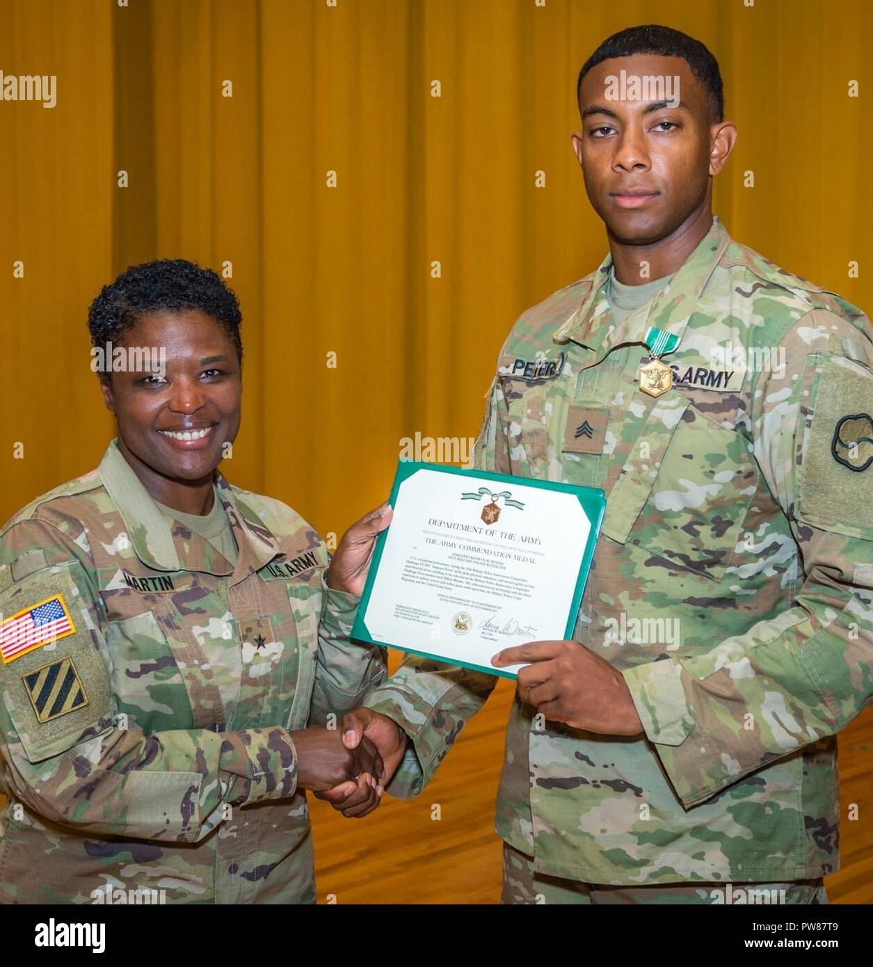 Sgt. Kenwyn H. Peters is presented the Army Commendation Medal and ...