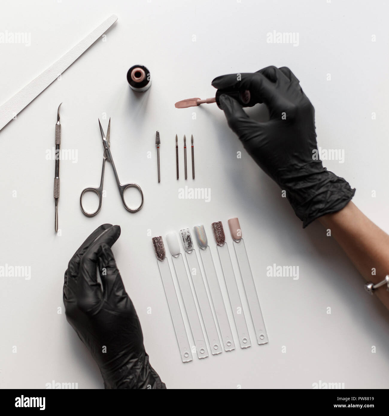 Concept nail care. A set of tools for nails. Female hands in black ...