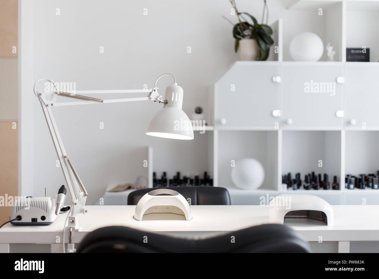 Interior studio for nail care. White room for manicure with a lamp and ...