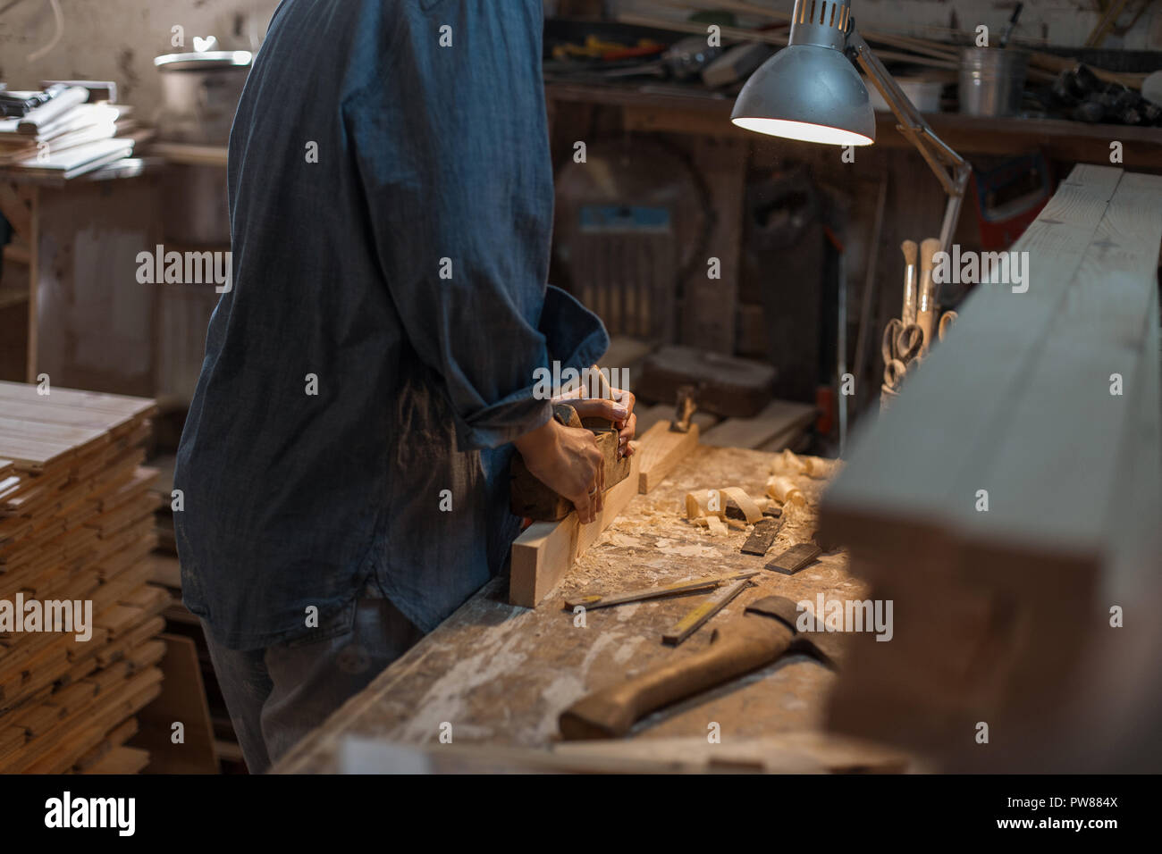 Manual female labor. Woman works in a wood workshop. Close-up of female ...