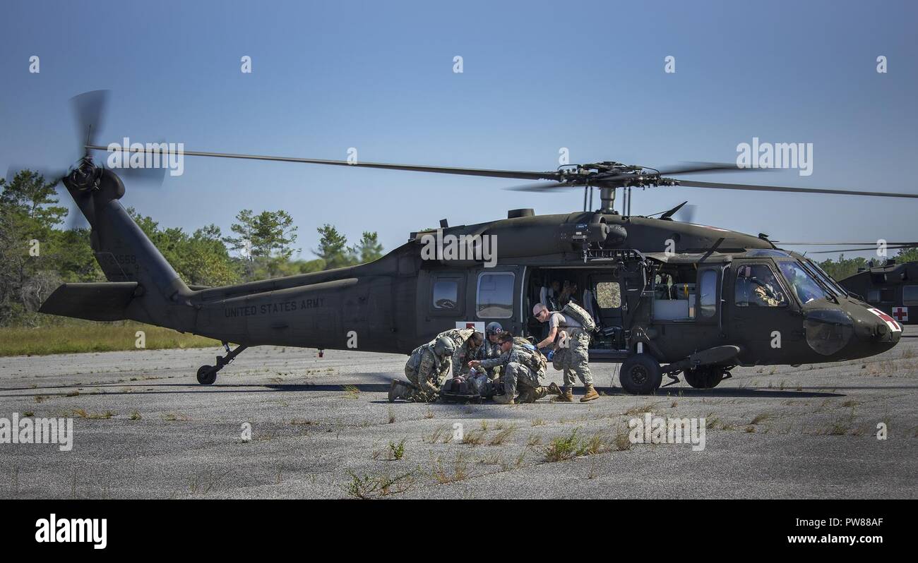 U.S. Army 6th Ranger Training Battalion members, load a simulated ...