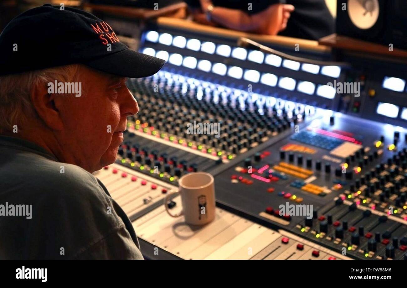 Jimmy Johnson listens to Army band members during a recording session ...