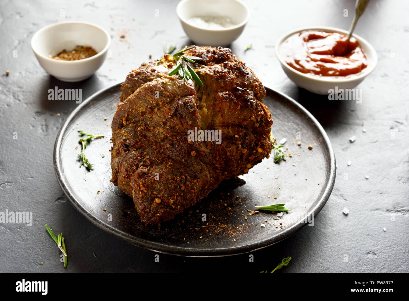 Grilled beef, barbecue meat on plate over black stone table Stock Photo ...