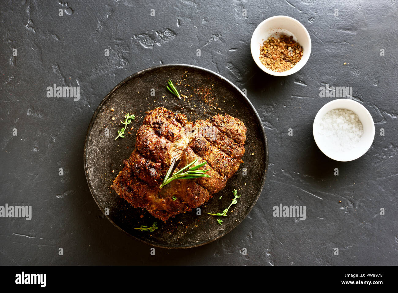 Barbecue meat. Grilled beef on plate over black stone background. Top ...