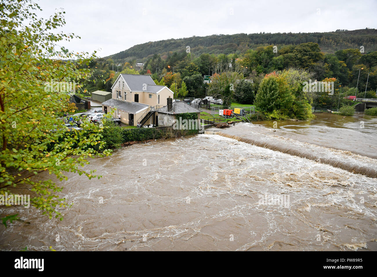The River Neath flows next to the Aberdulais Royal British Legion club ...