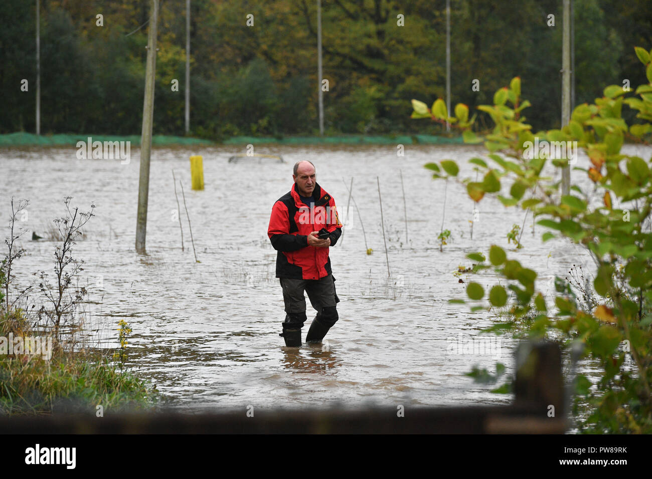 A man inspects a flooded golf driving range in Aberdulais, Neath, South ...