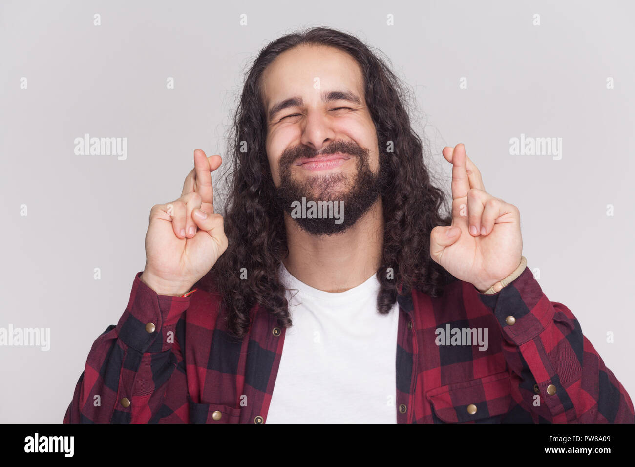 Handsome young man with long curly hair Stock Photo - Alamy